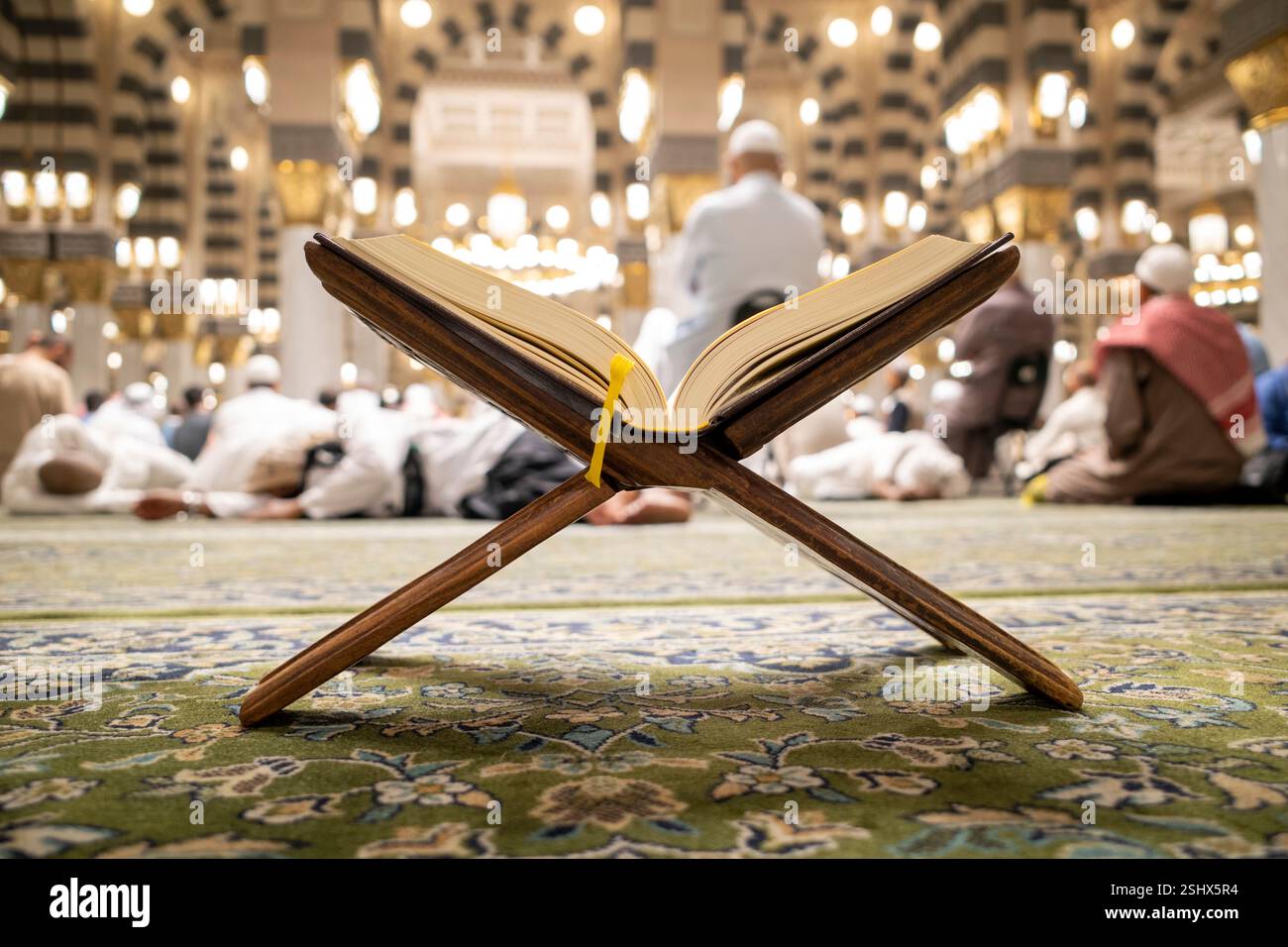 The holy book of the Quran is opened on a green carpet at the Prophet ...