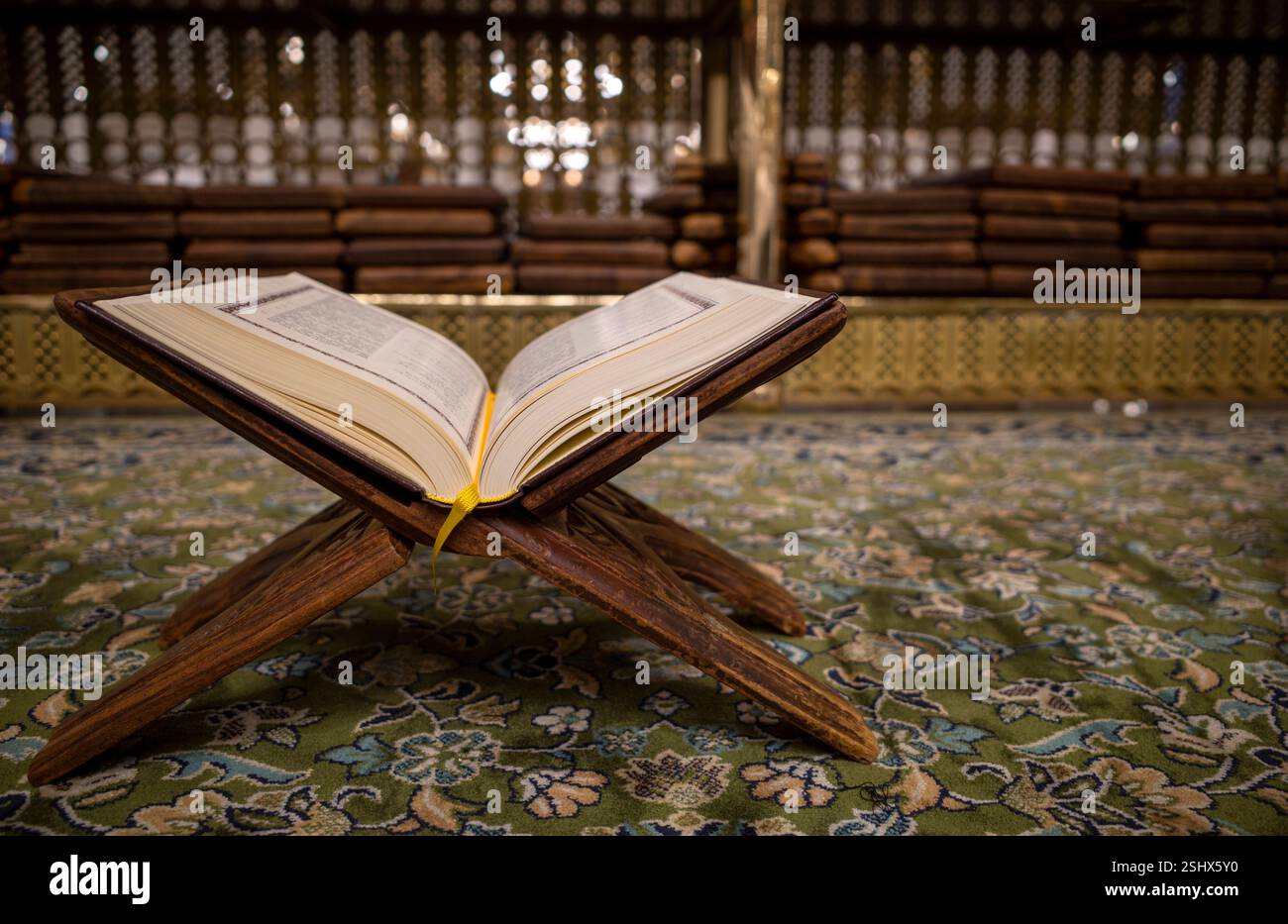 The holy book of the Quran is opened on a green carpet at the Prophet ...