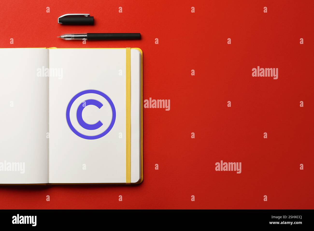License. Notebook with copyright symbol and pen on red background, top ...