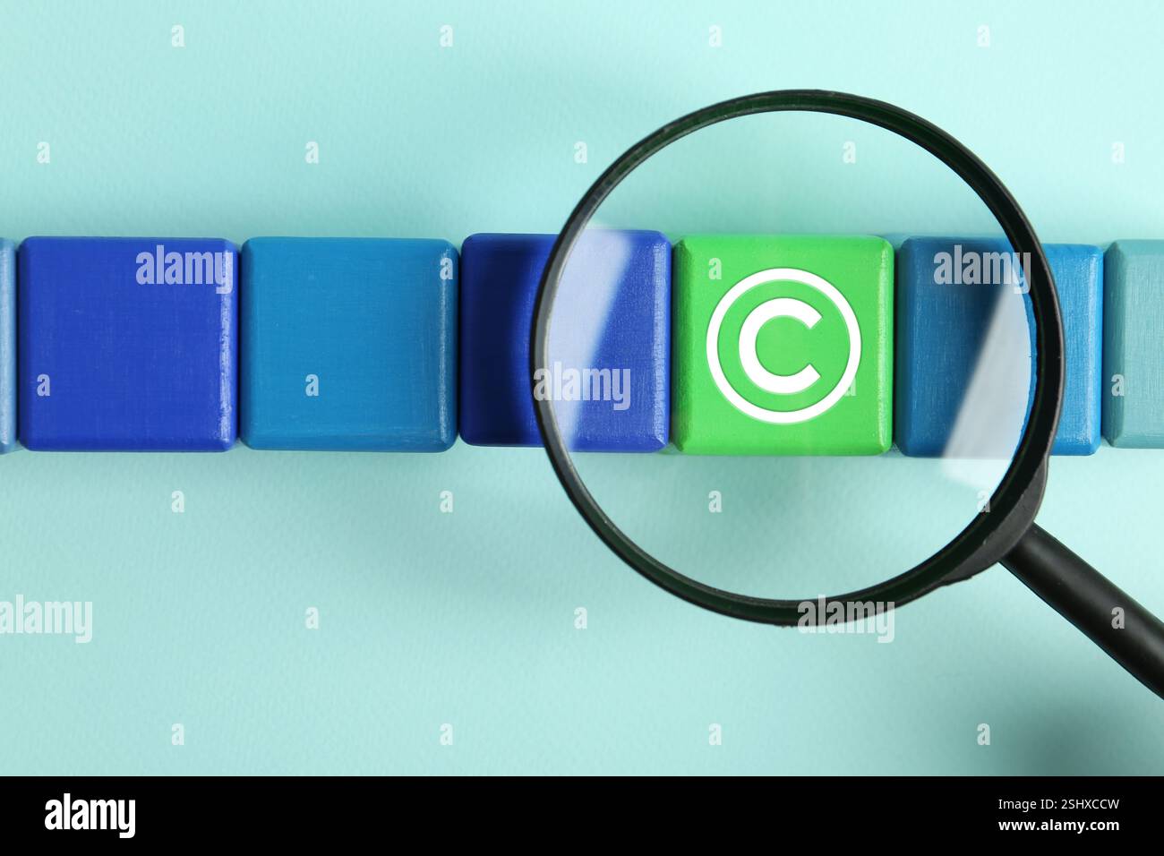 License. One green cube with copyright symbol among others on turquoise ...