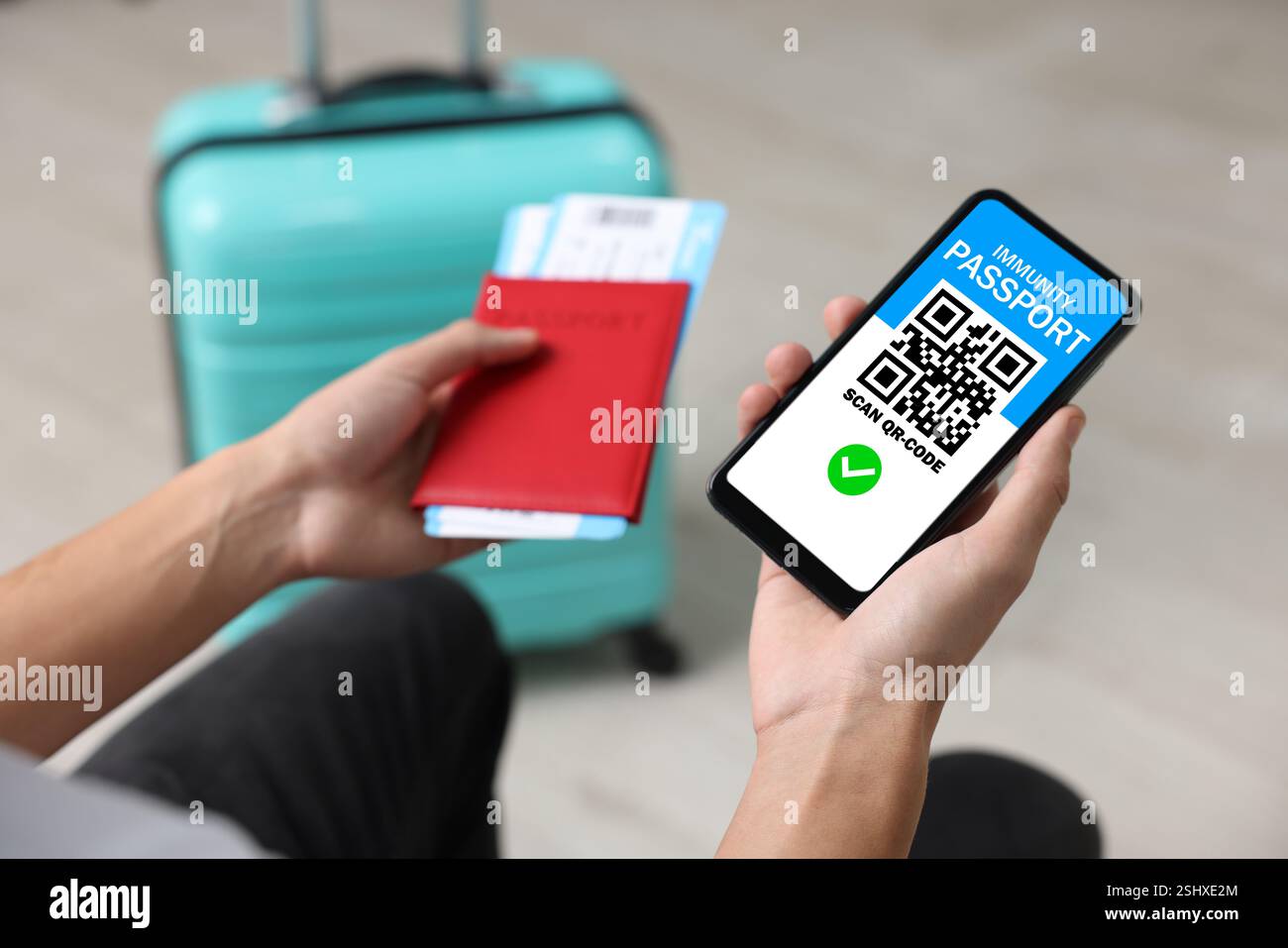 Tourist with passport, flight tickets and mobile phone indoors, above ...