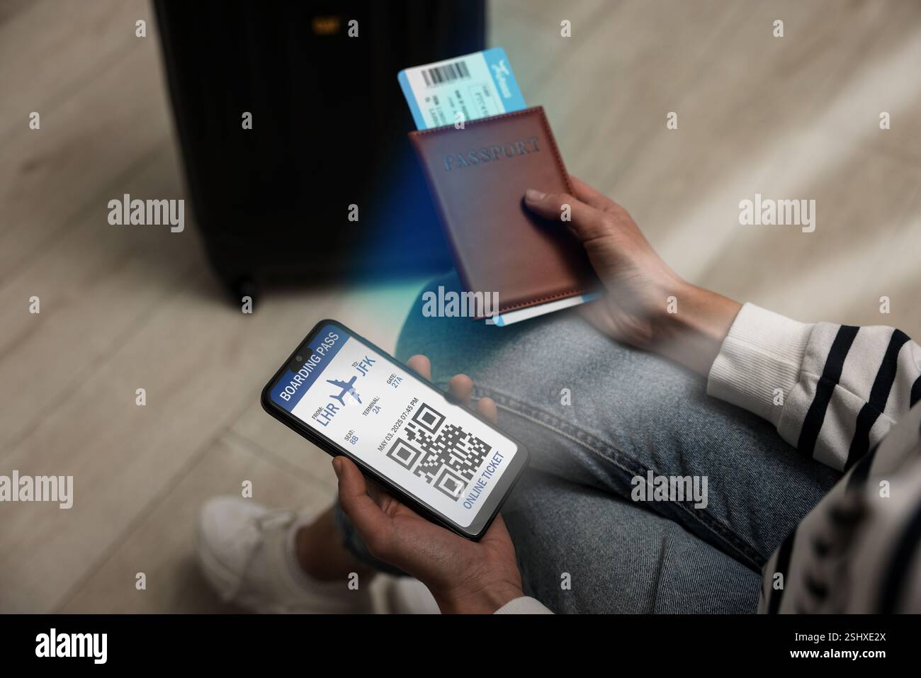 Tourist with passport, flight ticket and mobile phone indoors, above ...
