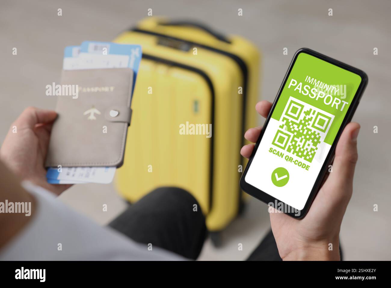 Tourist with passport, flight tickets and mobile phone indoors, above ...