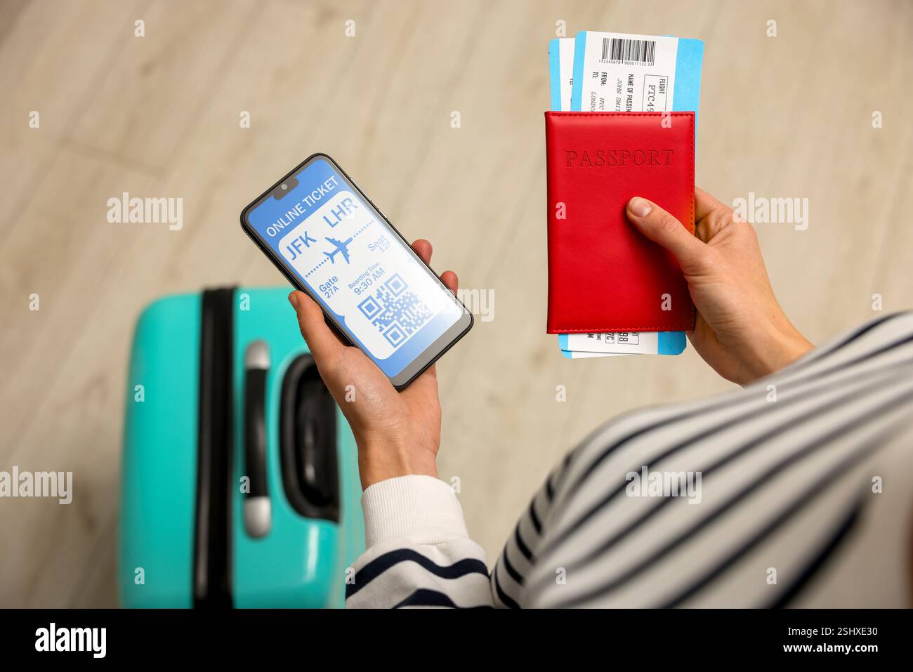 Tourist with passport, flight tickets and mobile phone indoors, above ...