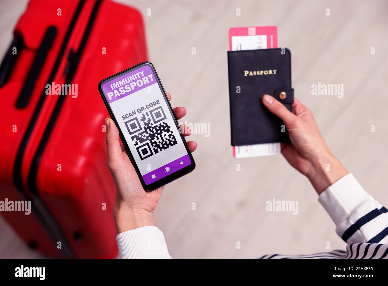 Tourist with passport, flight ticket and mobile phone indoors, above ...