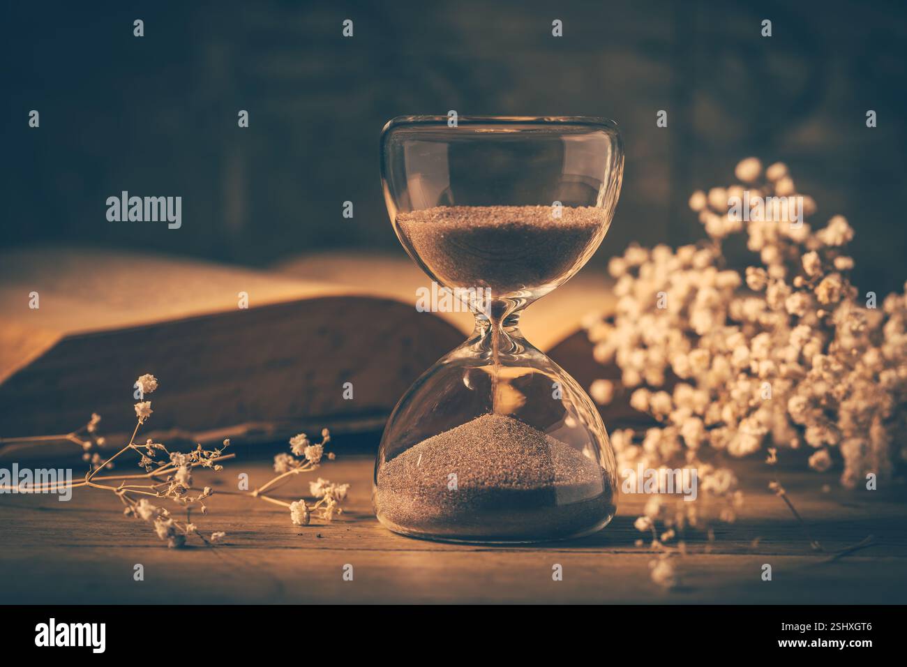 Hourglass with old book. Symbol of passing time and memories ...