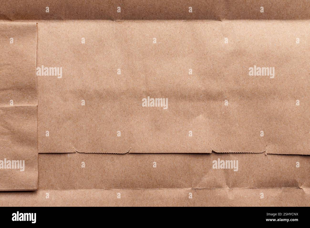Brown kraft paper folded with seams and structured edges. Layered ...