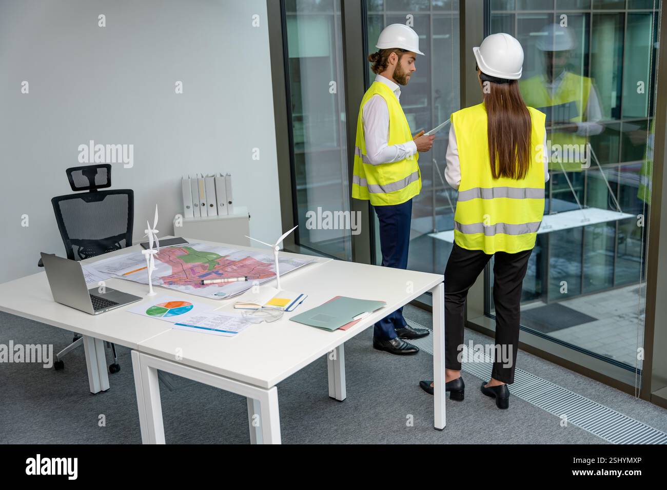 Engineers working together in the office on a new construction project ...