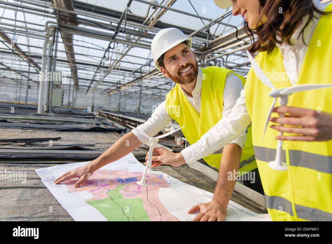 Two engineers discussing the construction plan and looking involved ...