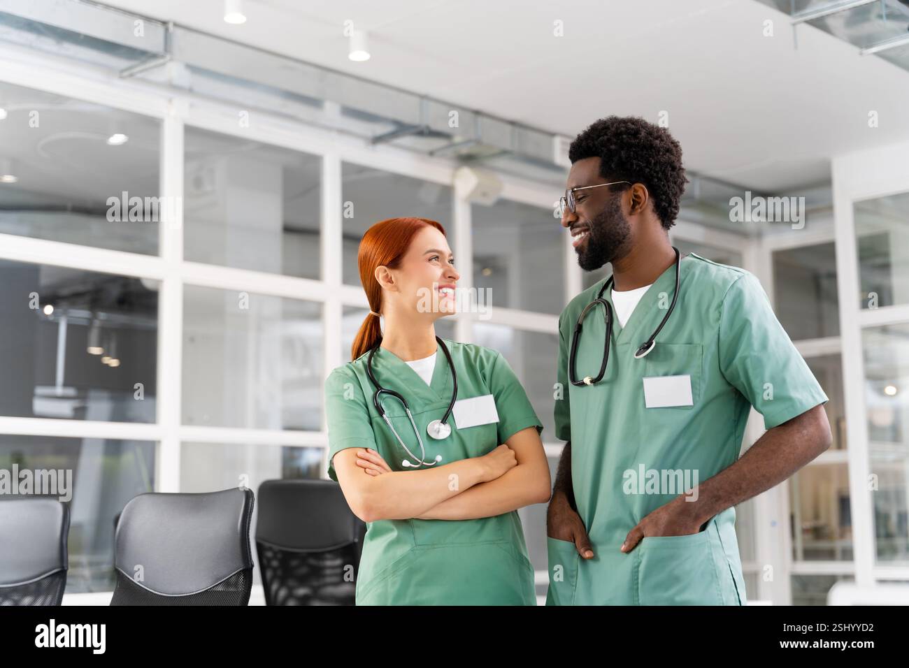 Female doctor and male colleague discussing health care strategies in ...