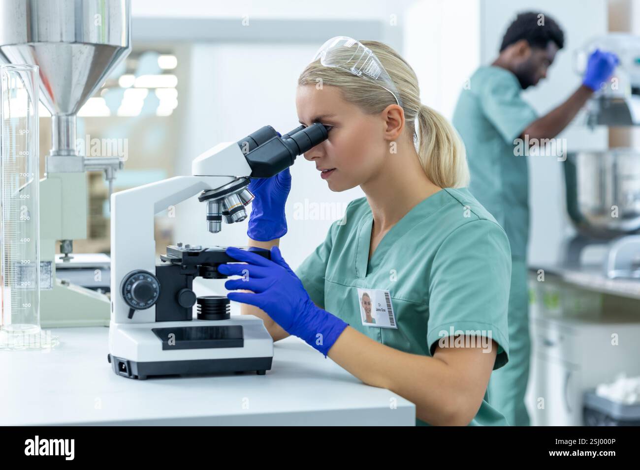 Woman researcher performing chemistry tests in scientific laboratory ...