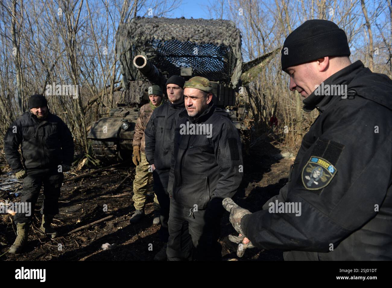 DONETSK REGION, UKRAINE - FEBRUARY 9, 2025 - Soldiers stay by a tank as ...