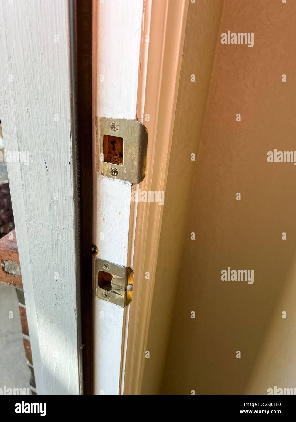 Door frame with missing latch hardware installed Stock Photo - Alamy