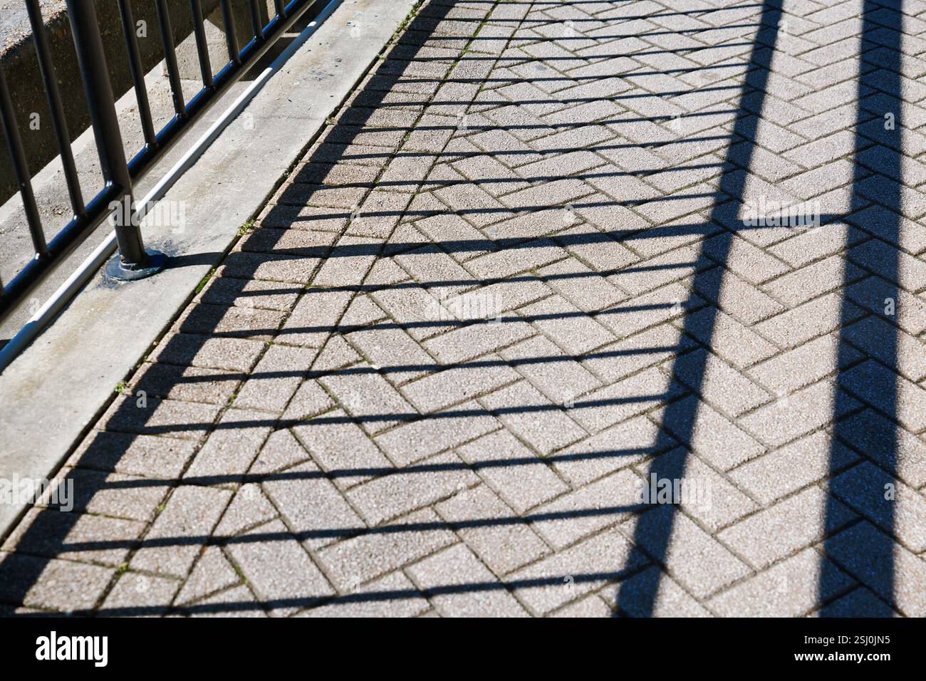 Shadows on the ground of a cobblestone footpath Stock Photo - Alamy