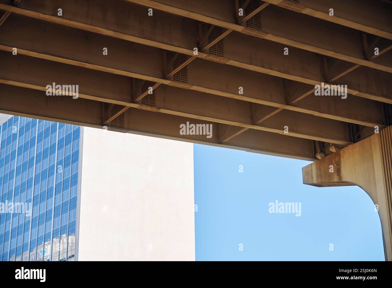 Low angle view of underneath a highway bridge and lower part of ...