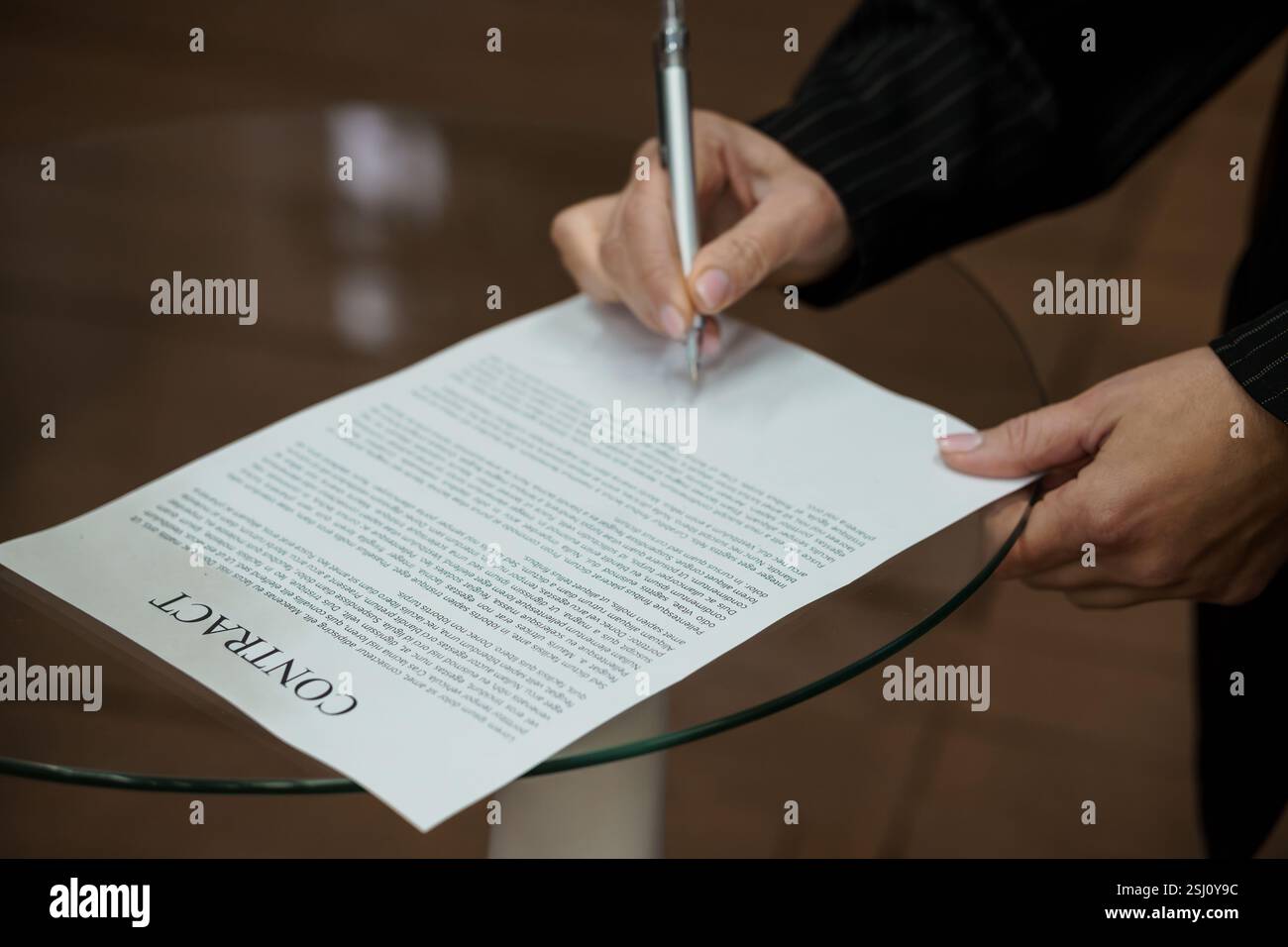 Signing a Contract on a Glass Table Stock Photo - Alamy