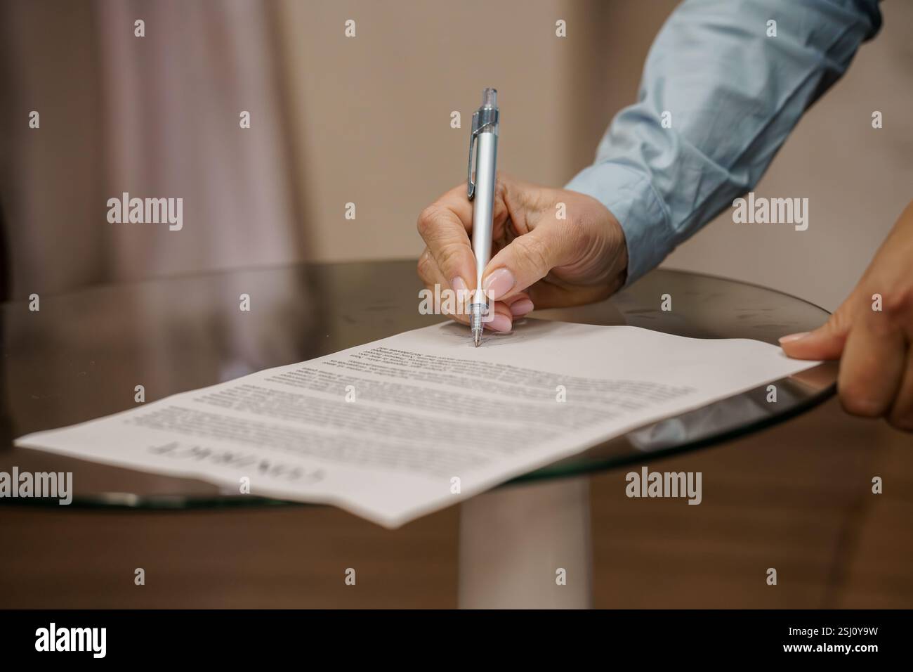 Signing a Formal Document with a Pen on a Glass Table Stock Photo - Alamy