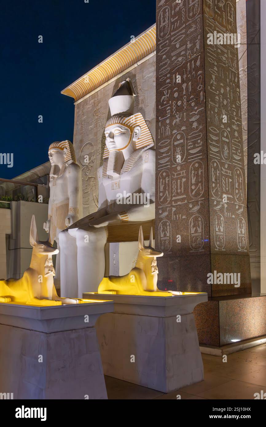 Giant Pharaohs and columns engraved with Egyptian hieroglyphics stand ...