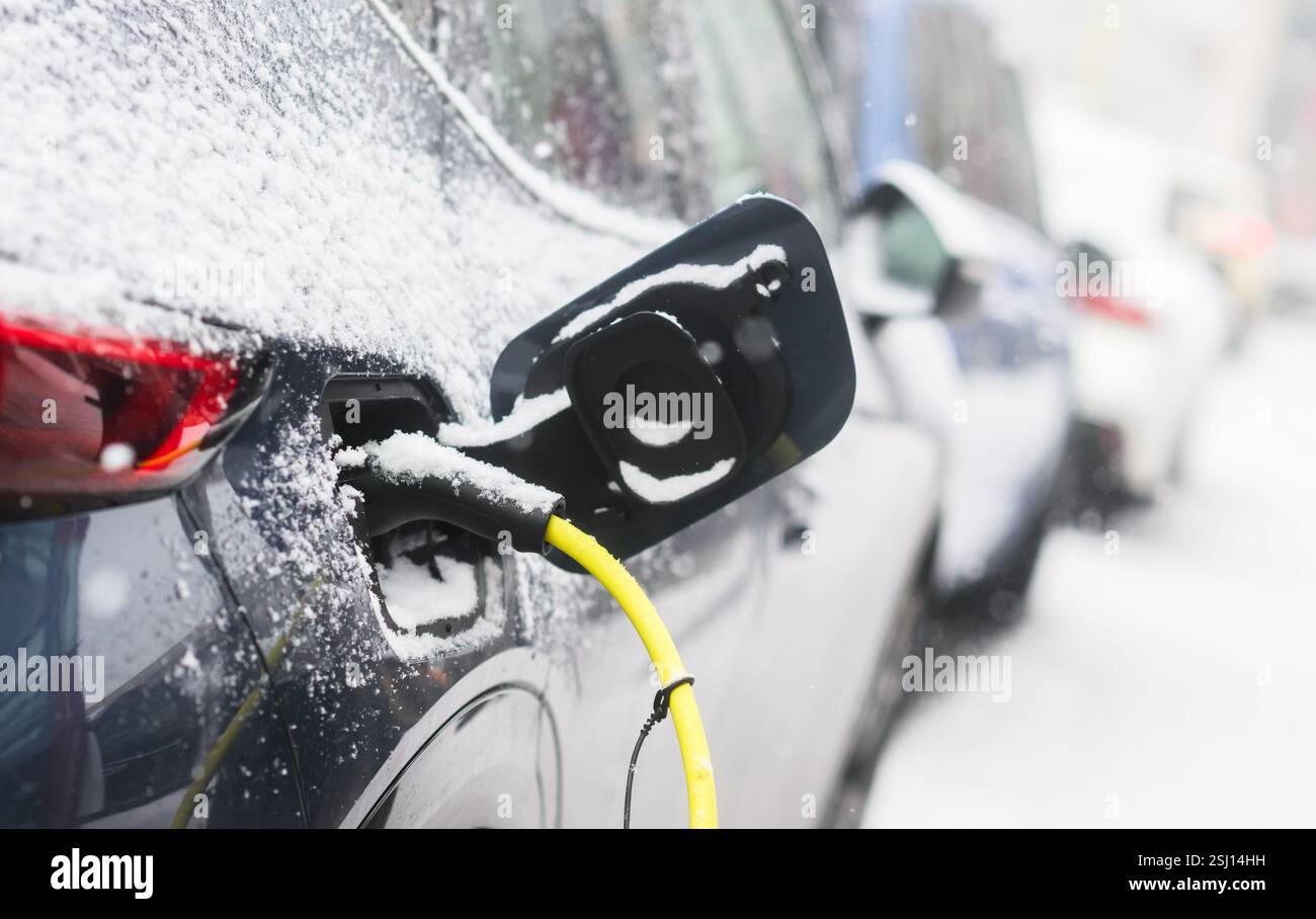Hanover, Germany. 11th Feb, 2025. Snow lies on a charging cable used to ...