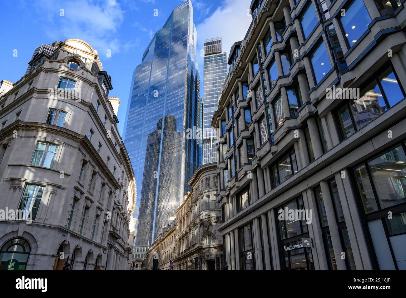 Modern glass fronted office buildings tower over historic Threadneedle ...