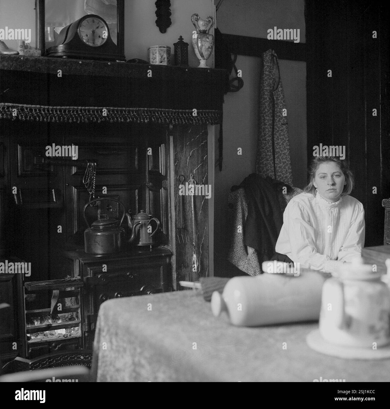 1900's home UK. Black Country Museum. Female employee in a preserved 1800's/early . Victorian ...