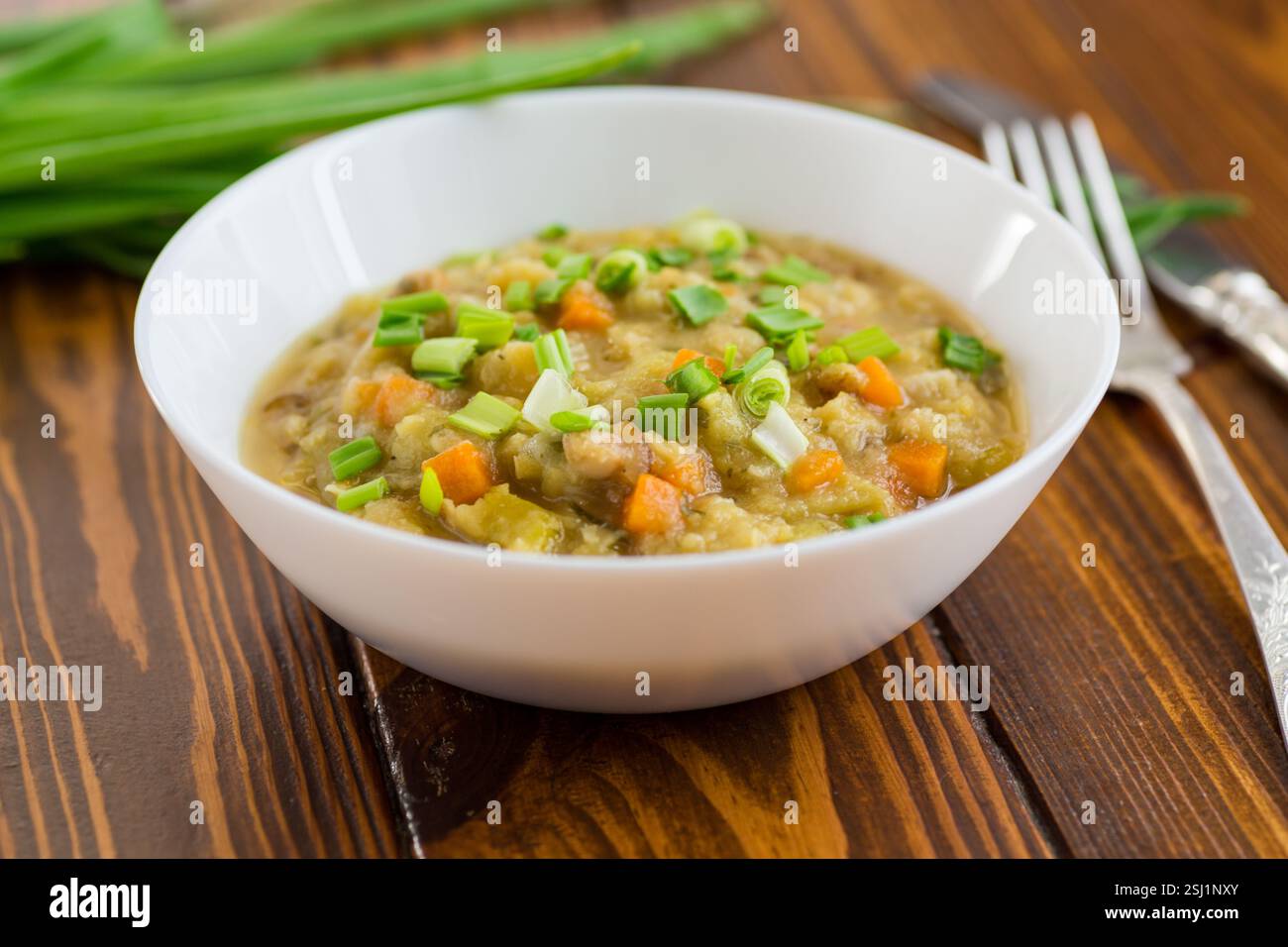 Pea porridge with onions and greens Stock Photo - Alamy
