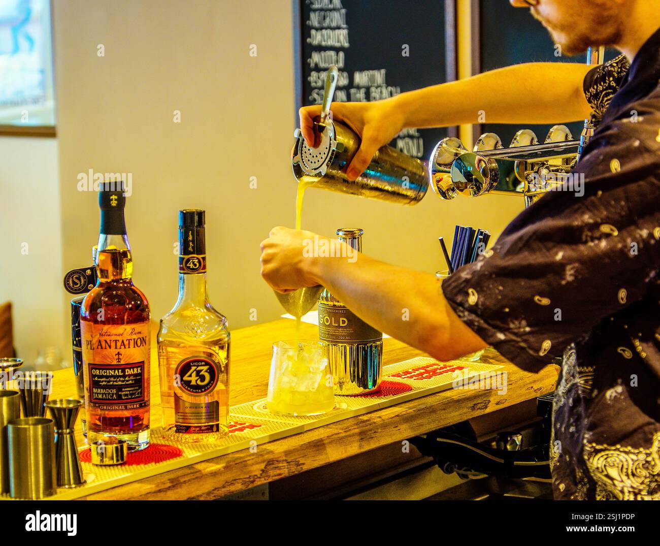 Barman preparing a cocktail in a UK restaurant Stock Photo - Alamy