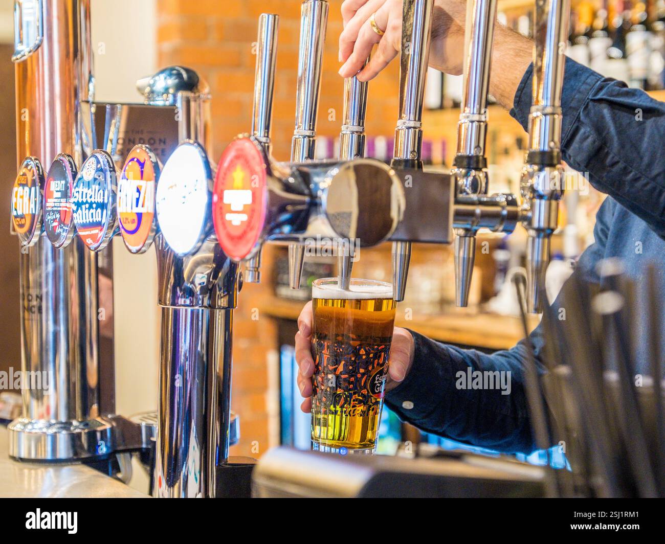 Pulling a pint in a bar, UK Stock Photo - Alamy