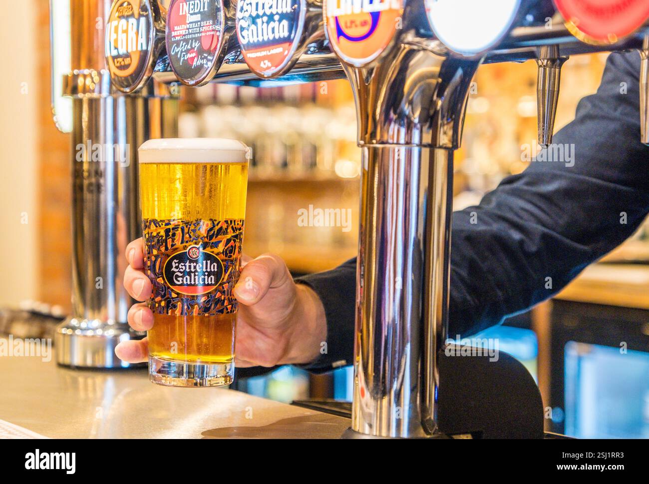 Pulling a pint in a bar, UK Stock Photo - Alamy