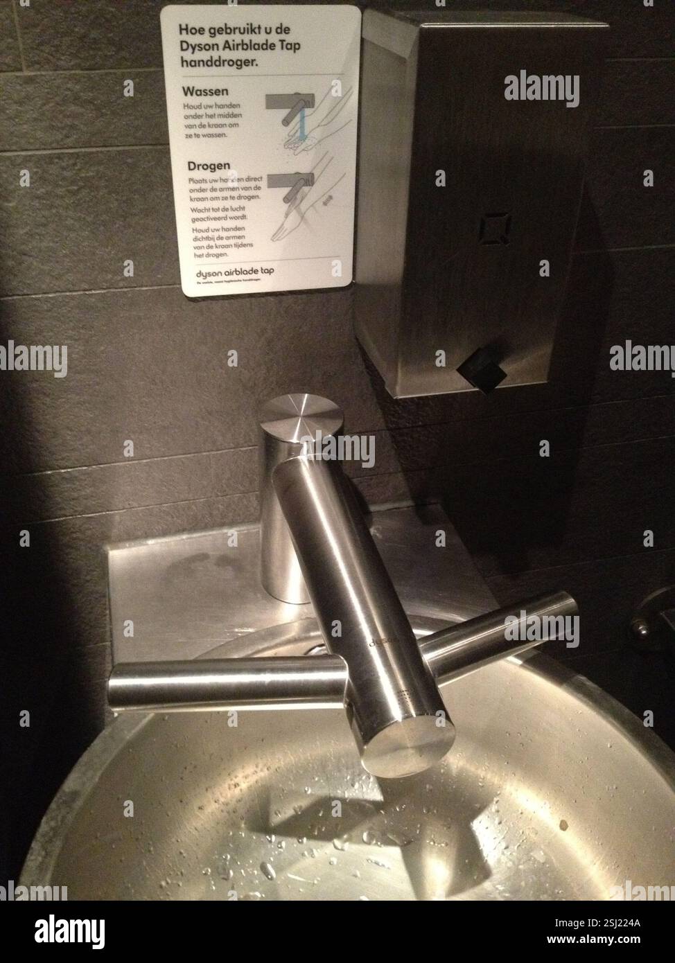 A modern sink in Amsterdam with a built-in Dyson Airblade Tap hand ...