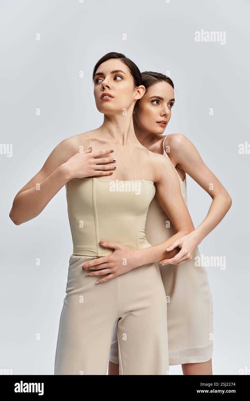 Two beautiful twin sisters pose gracefully together, showcasing their ...