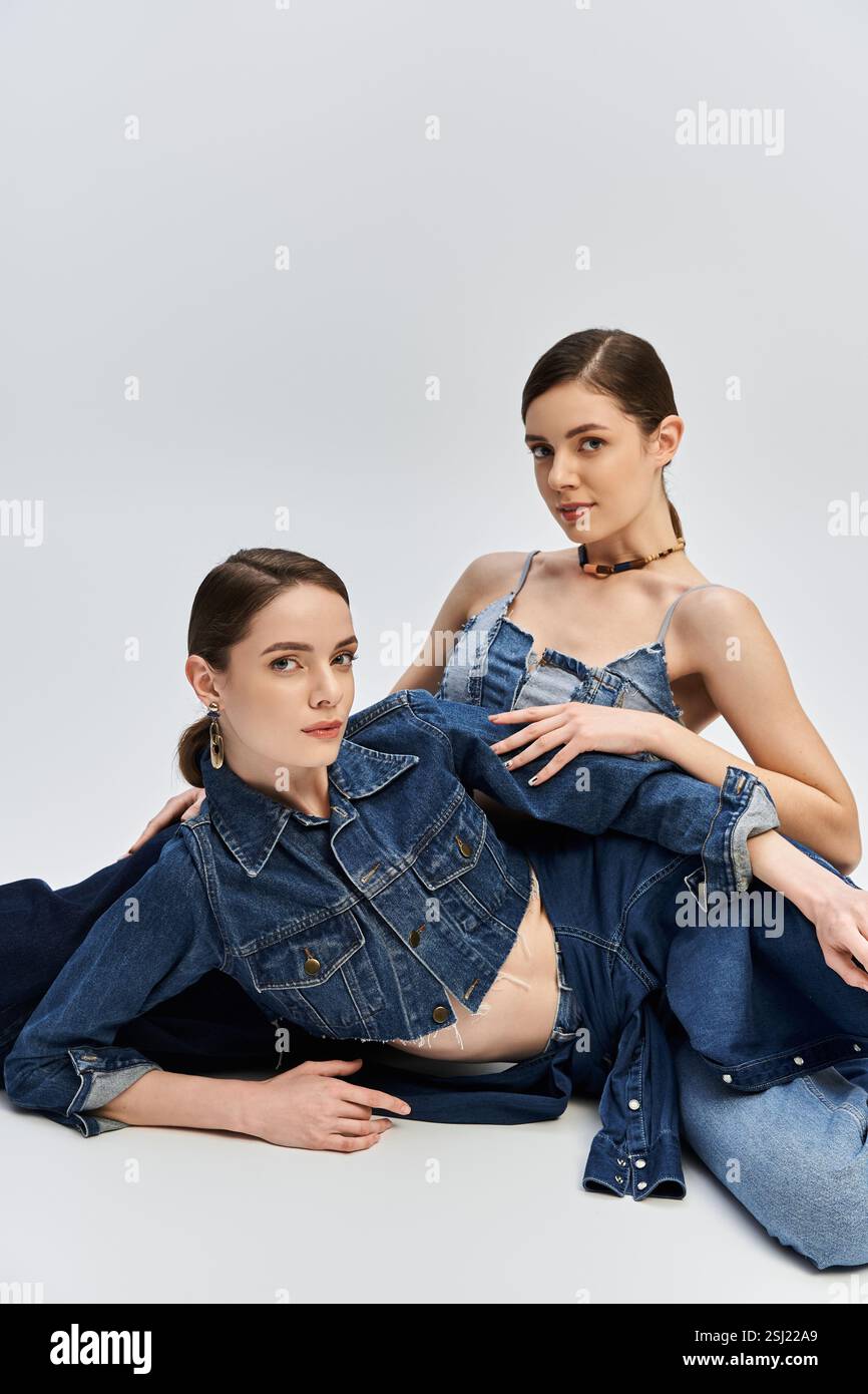 Two beautiful sisters pose gracefully in trendy denim outfits, exuding ...