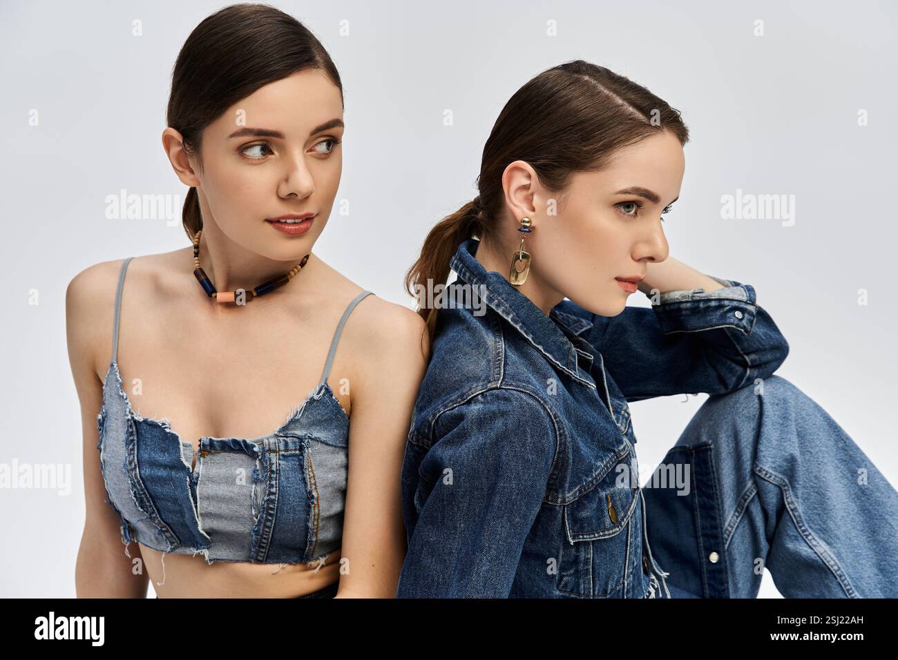 Two beautiful twin women model trendy denim outfits, exuding elegance ...