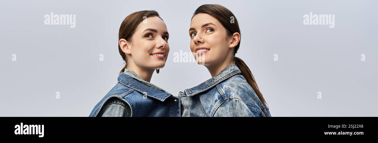 Two beautiful twin sisters smile brightly as they pose side by side ...