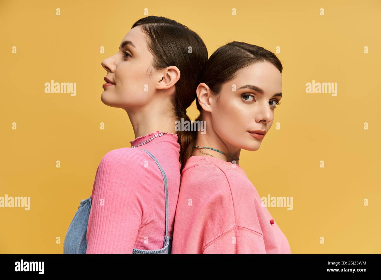 Two sisters stand back to back, showcasing their styles and strong bond ...