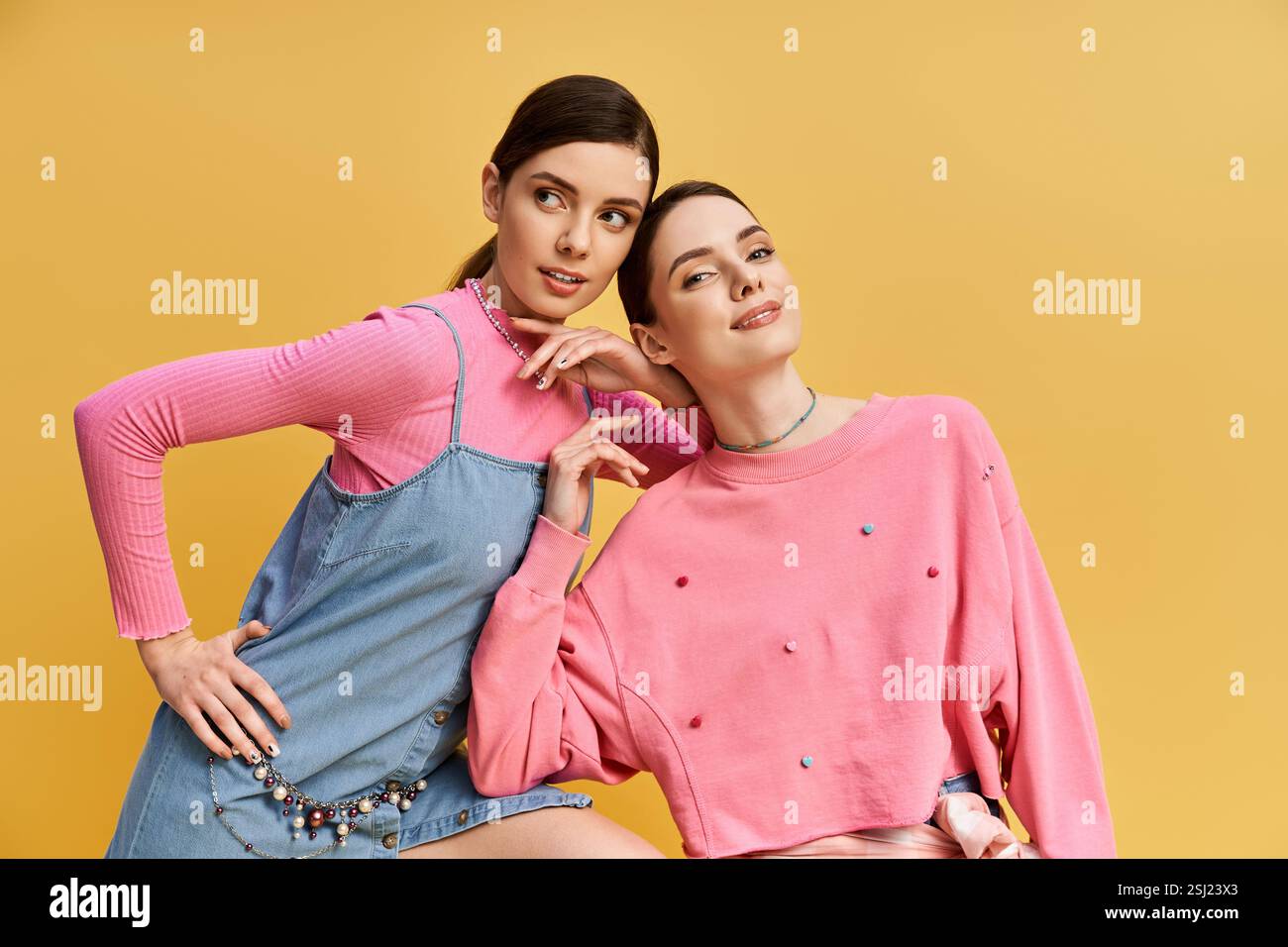 Two beautiful sisters pose together in stylish outfits that reflect ...