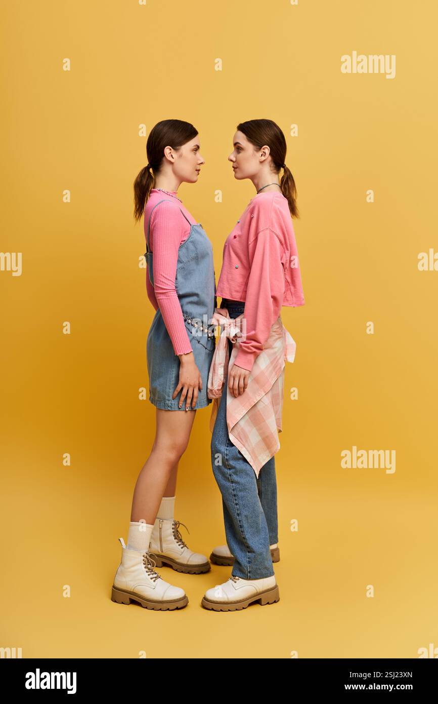 Two beautiful sisters face each other, showcasing their stylish looks ...