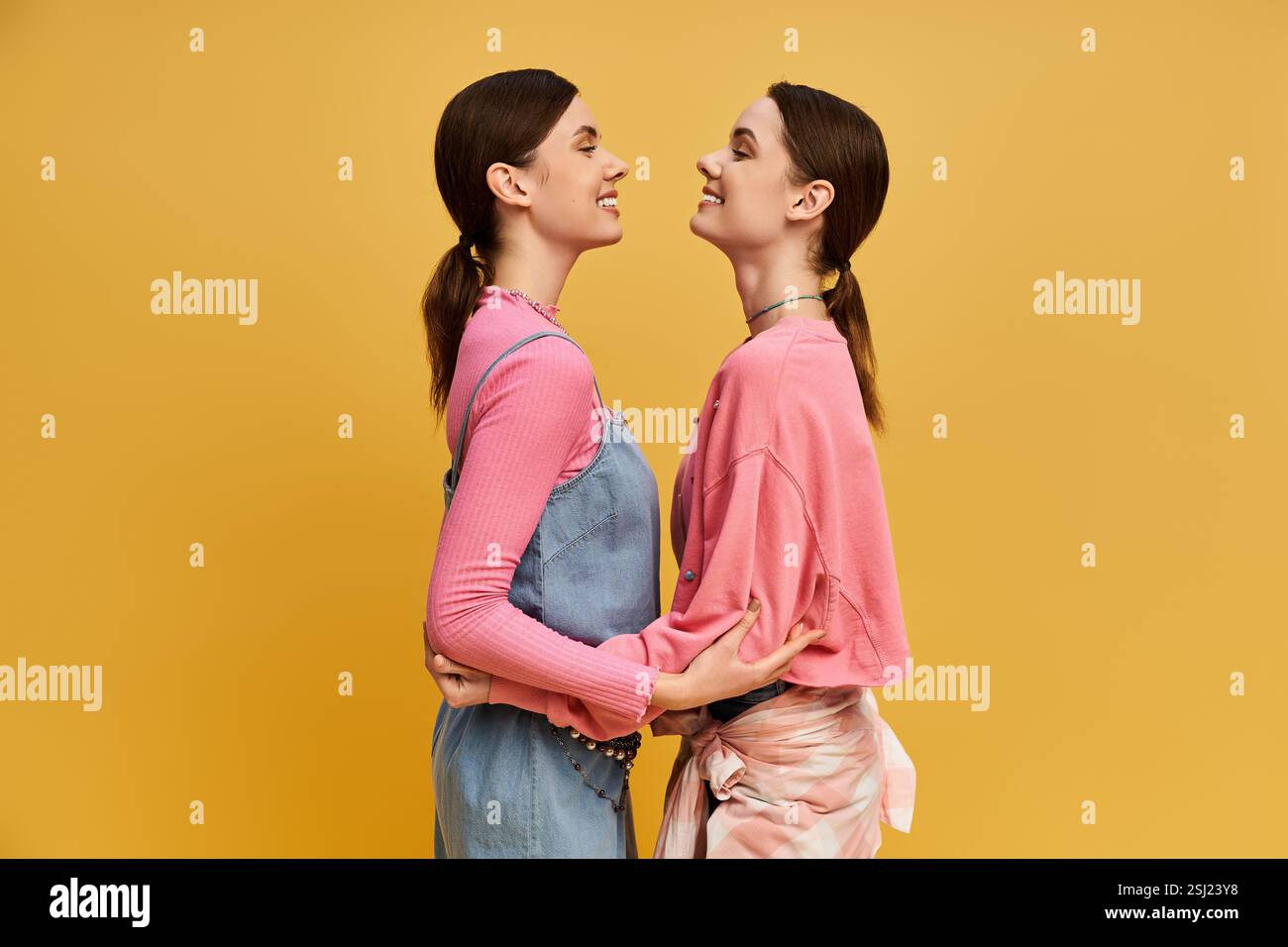 Two smiling sisters embrace, highlighting their close bond and stylish ...