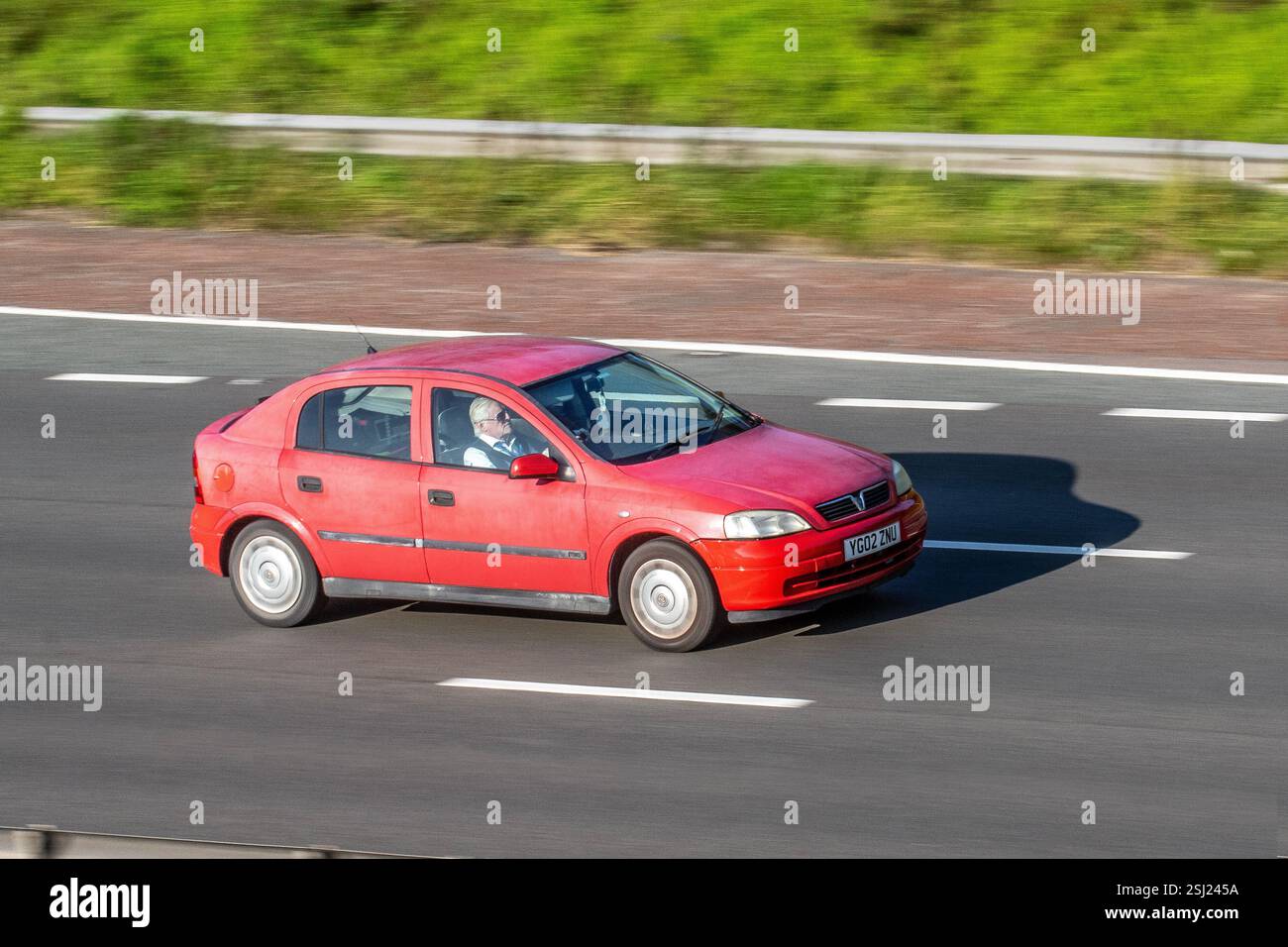 2002 Red sun faded Vauxhall Astra Club 8V, a fourth-generation Astra 1. ...