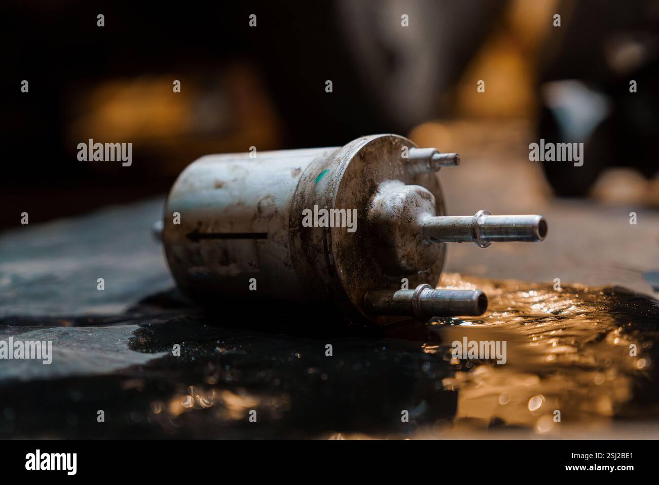 Rusty Fuel Filter on a Mechanic’s Floor Surrounded by Oil Stock Photo ...