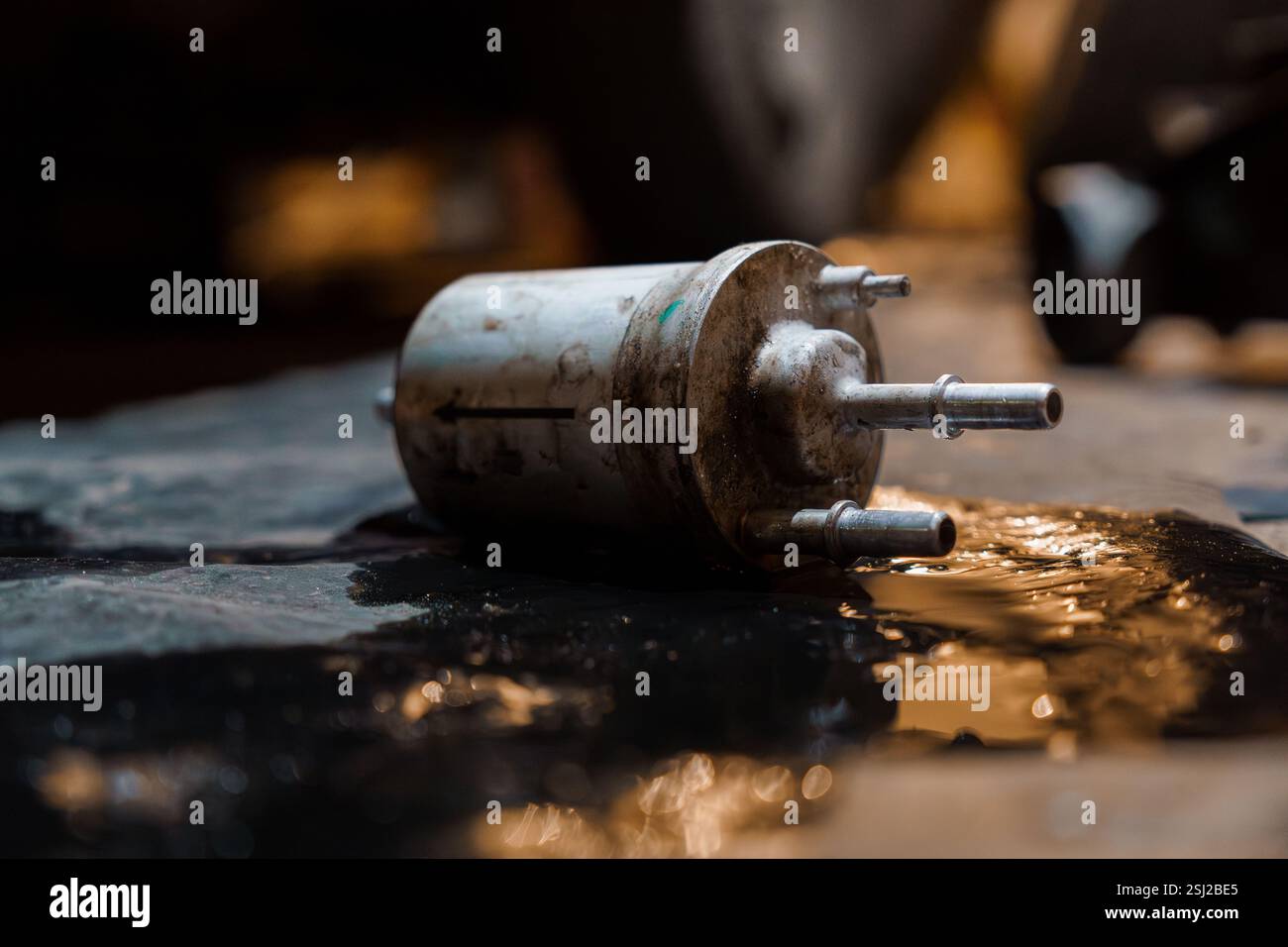Rusty Fuel Filter on a Workshop Floor with Spill Stock Photo - Alamy