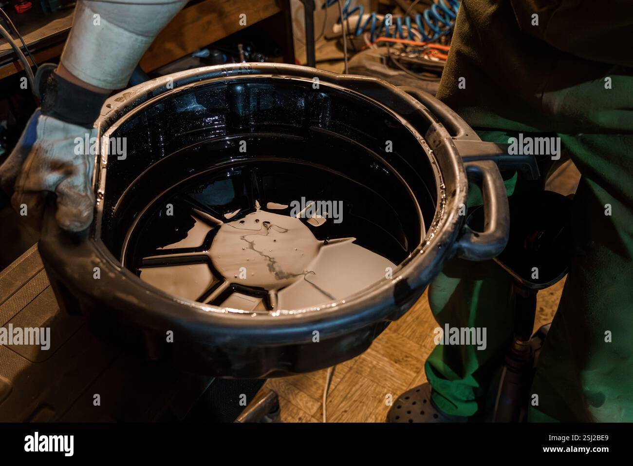 Industrial Oil Collection in Workshop Setting Stock Photo - Alamy