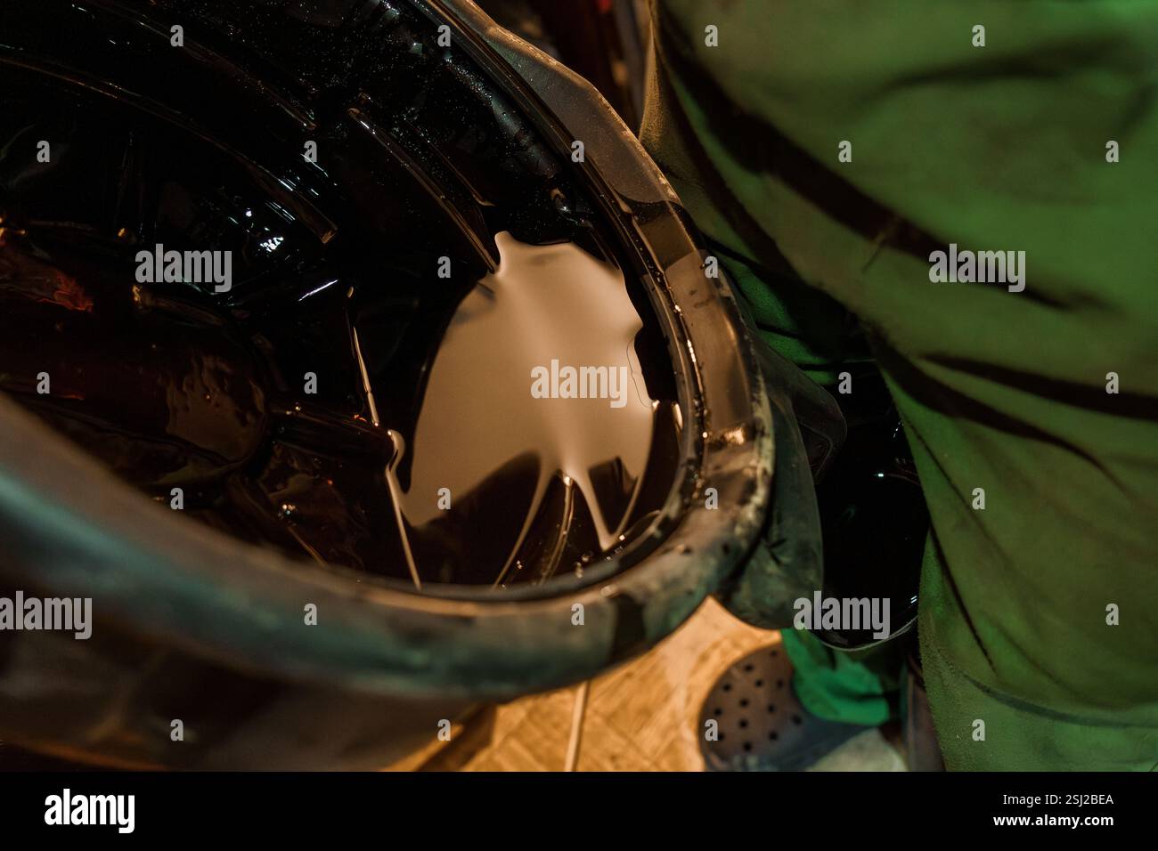 Oil Drainage Process in a Workshop Setting Stock Photo - Alamy
