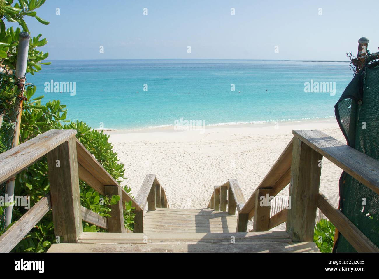 Staircase leading to a pristine beach in the Bahamas. The stairs offer ...