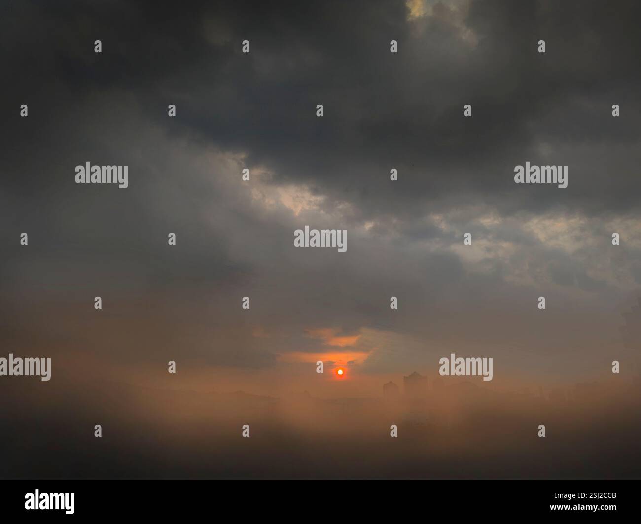 Setting sun disc near horizon, misty,hazy,aerial pollution Stock Photo ...