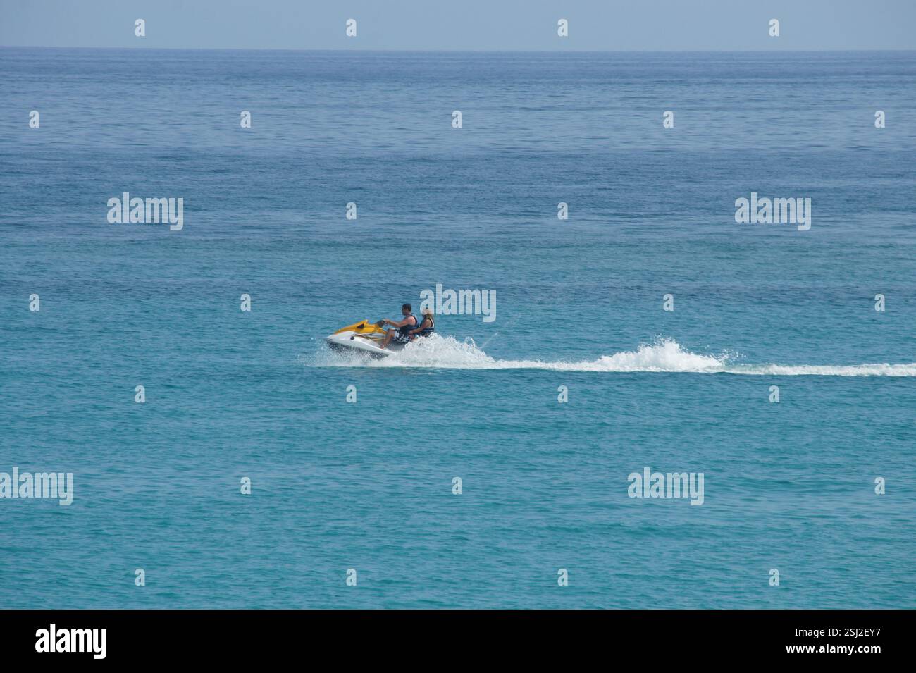 Jet ski Bahamas speeding across ocean waves. Watercraft creates wake as ...