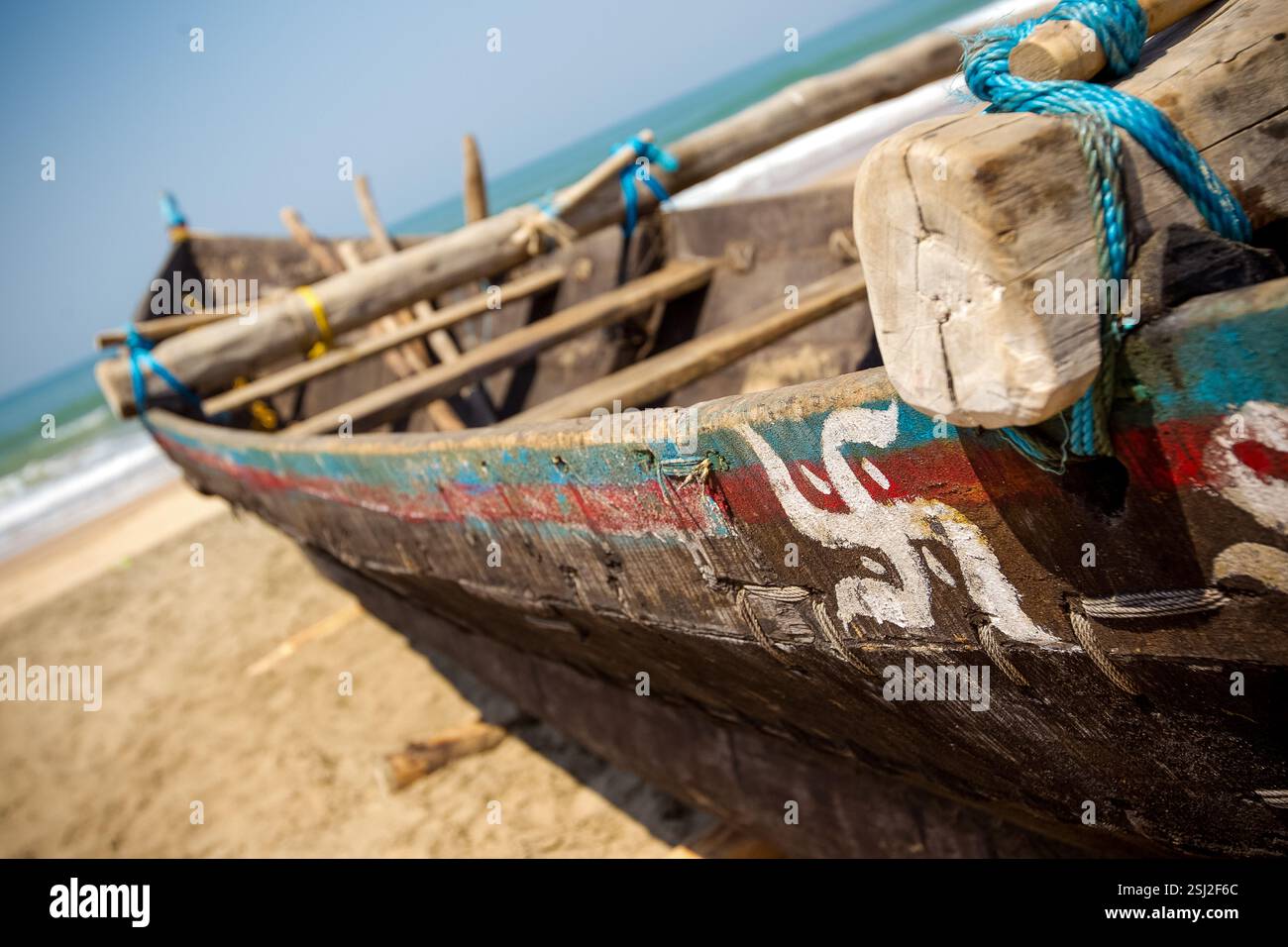 Palm trees and fishermen's boats on the golden sands of Agonda beach in ...