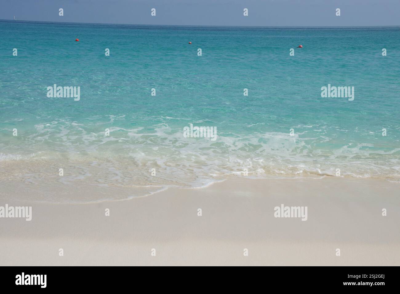 Beach. White sand meets turquoise water with gentle waves. Idyllic ...
