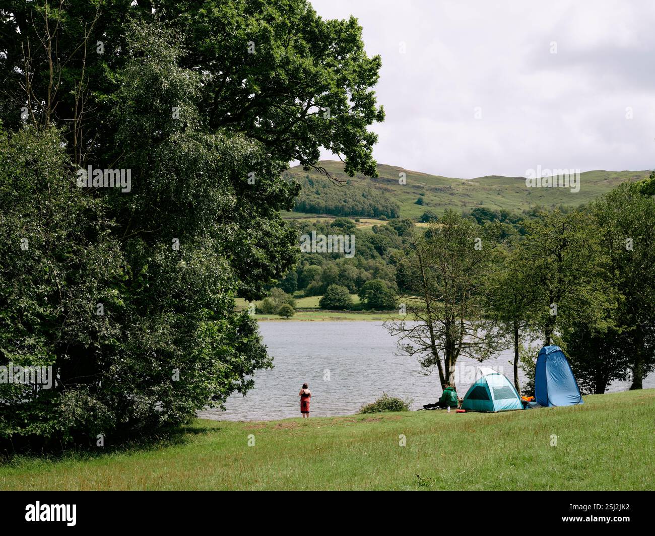Summer visitors enjoying Coniston Water in the Lake District National ...