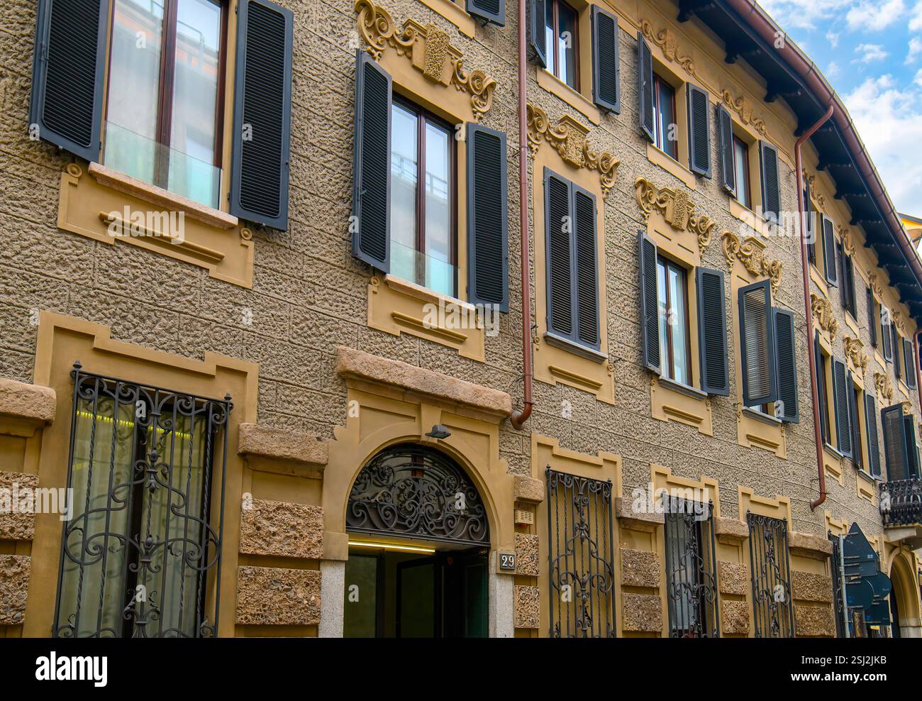 Milan, Italy. Traditional colorful building with balconies, shutter ...